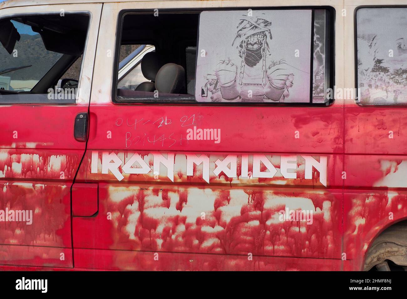 Side view of red van of an Iron Maiden fan, scrap car, scrap yard ...