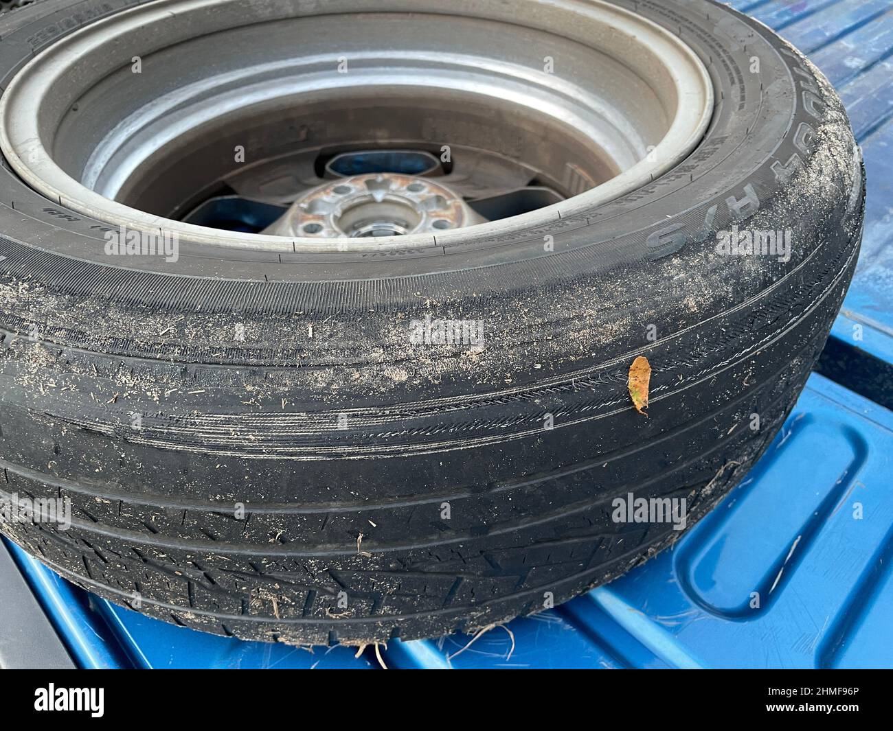 Upside down bad tire on the bed of a blue pickup truck Stock Photo - Alamy