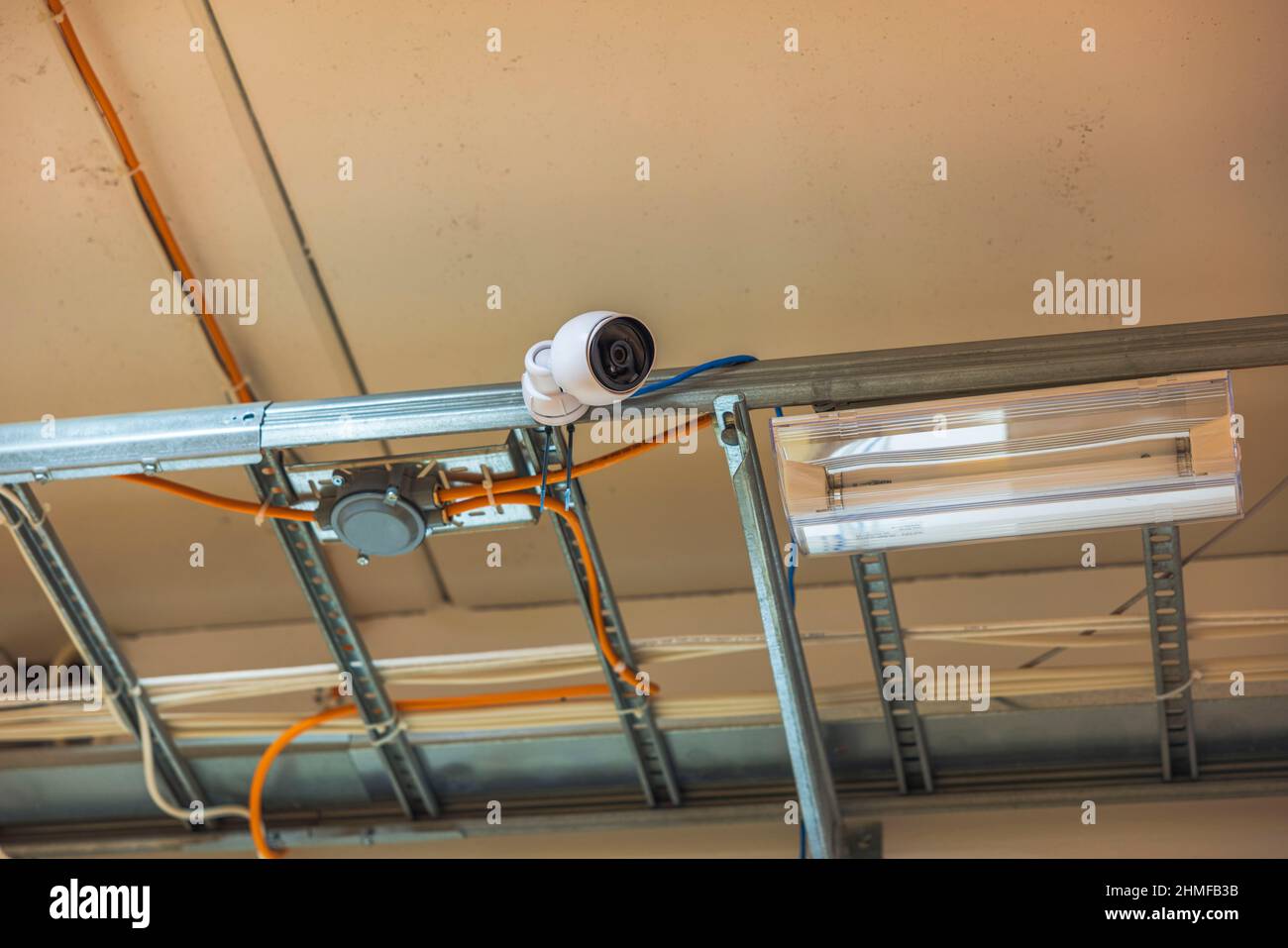 Close up view of modern surveillance safety camera under ceiling ...