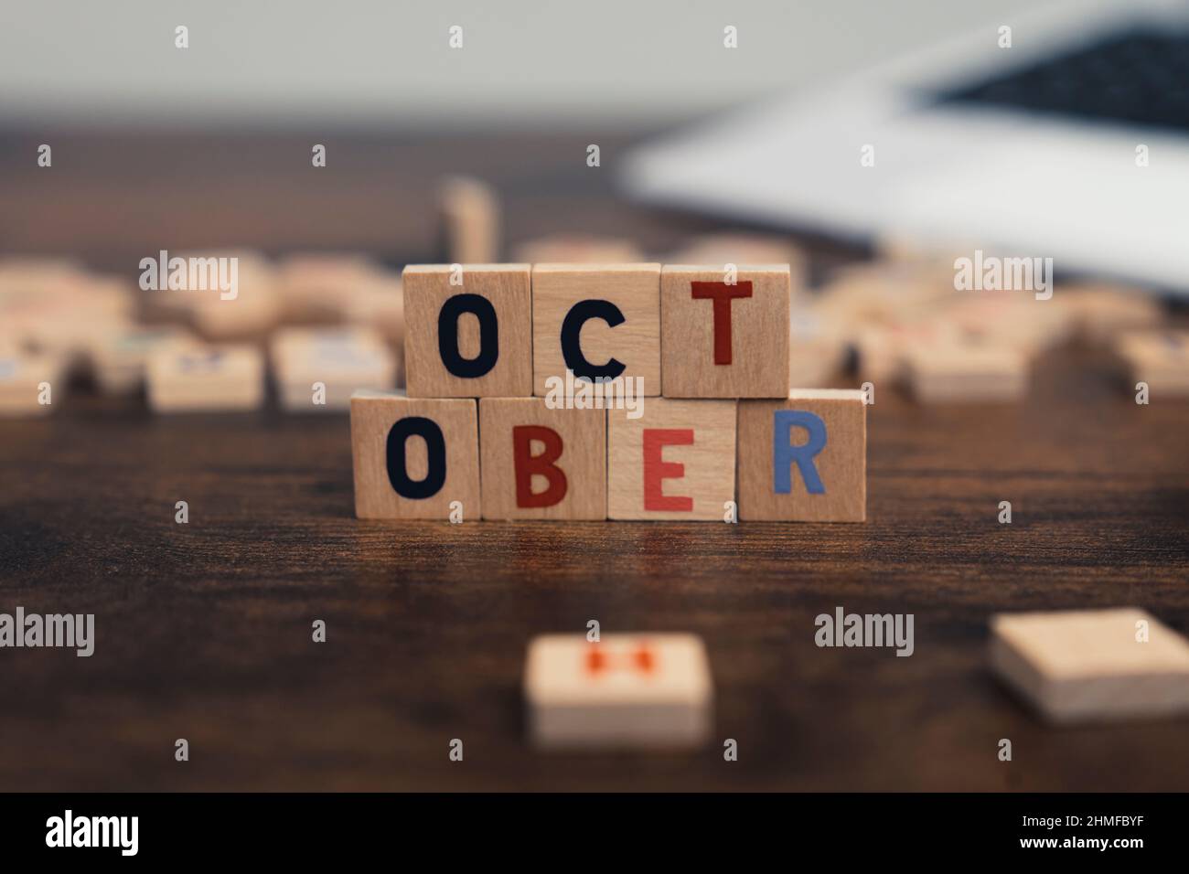 The name of the month October written on wooden cubes od the tabletop ...