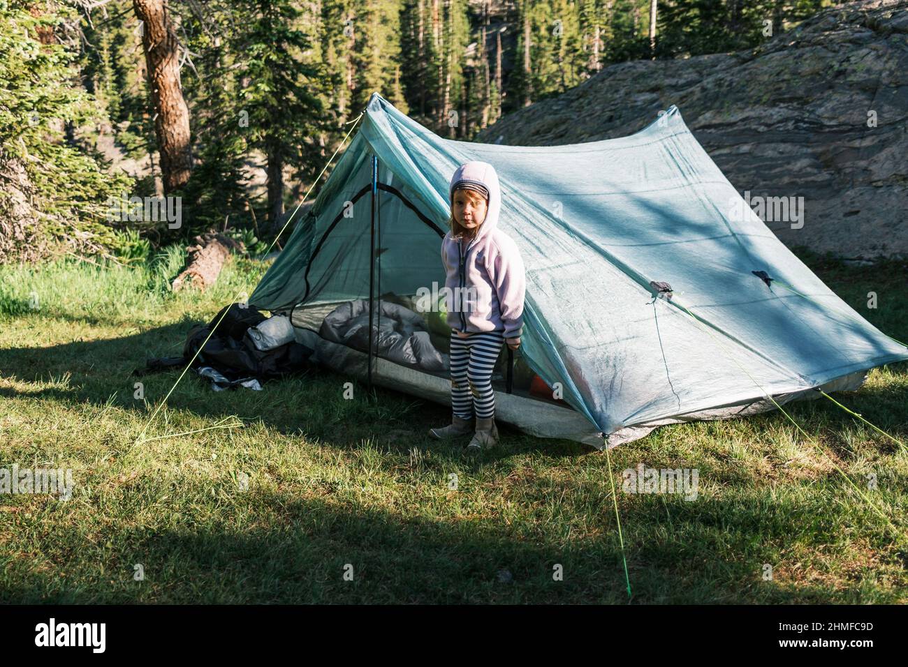 Young girl standing in front of her tent in Colorado Stock Photo - Alamy