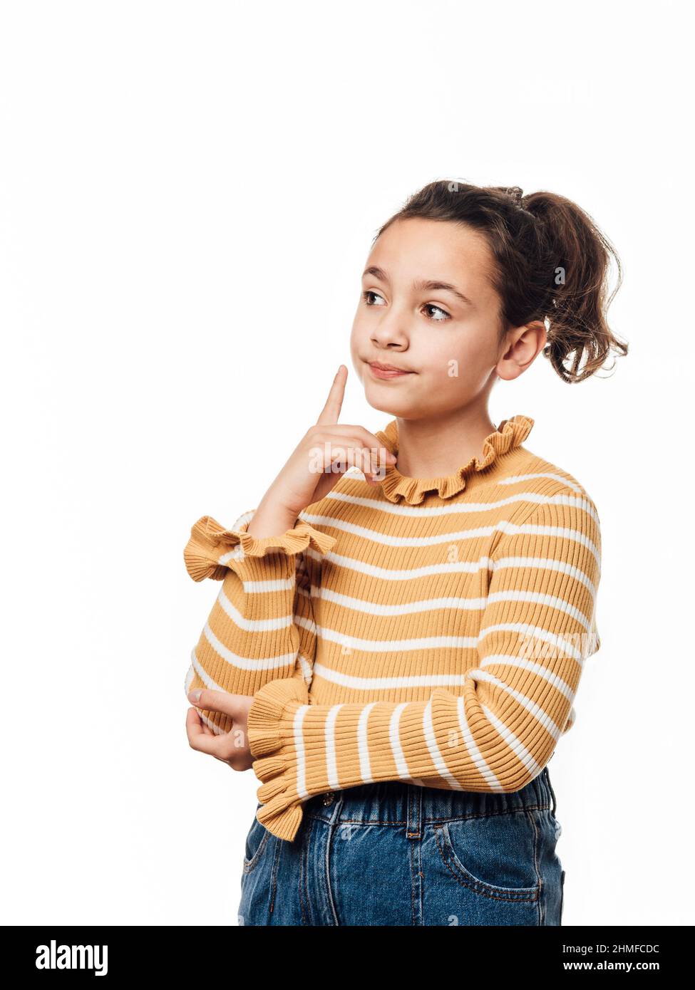 Pensive young girl thinking about something while standing over an ...