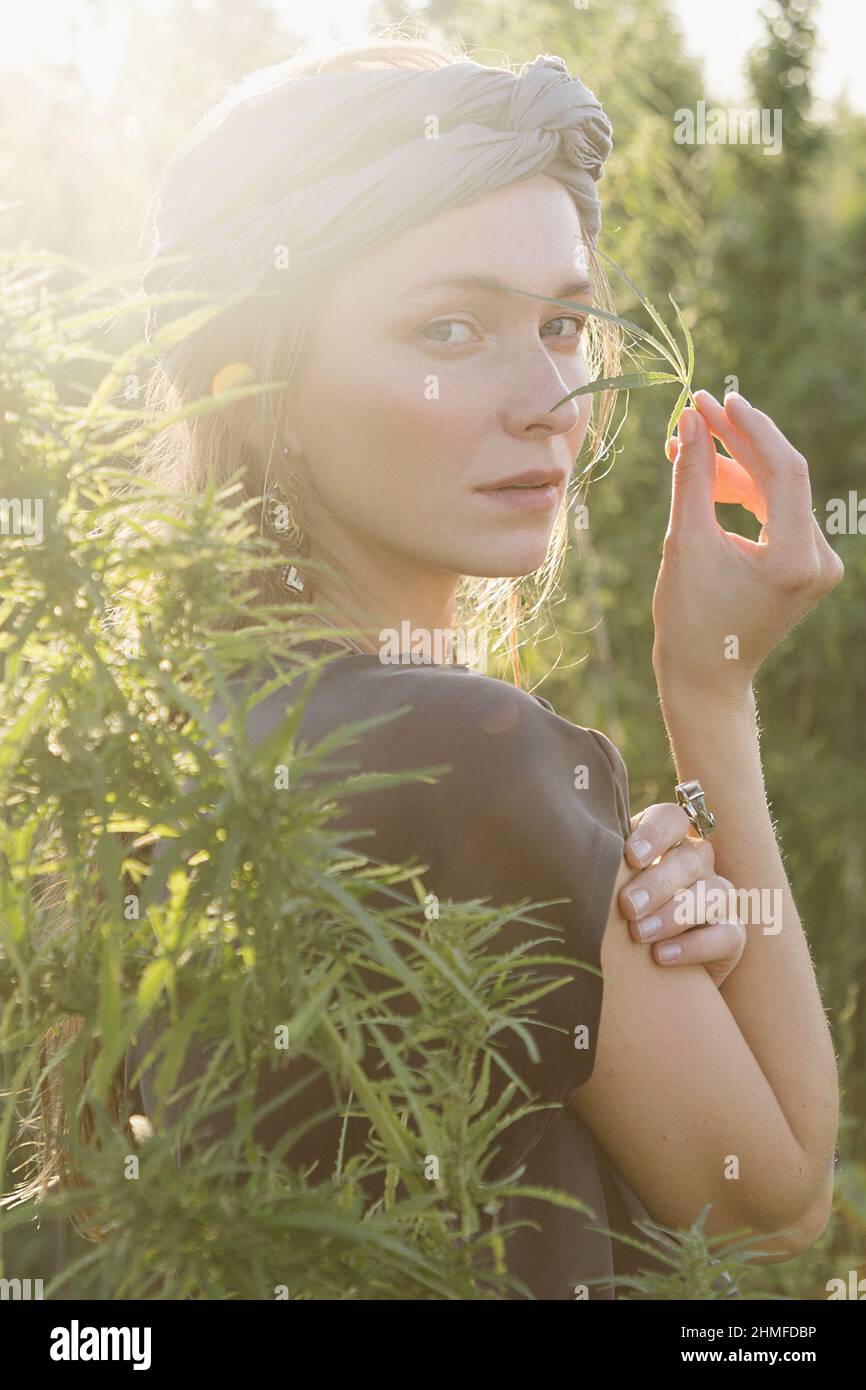Woman in the Cannabis plant, Girl standing with Marijuana or Hem Stock ...