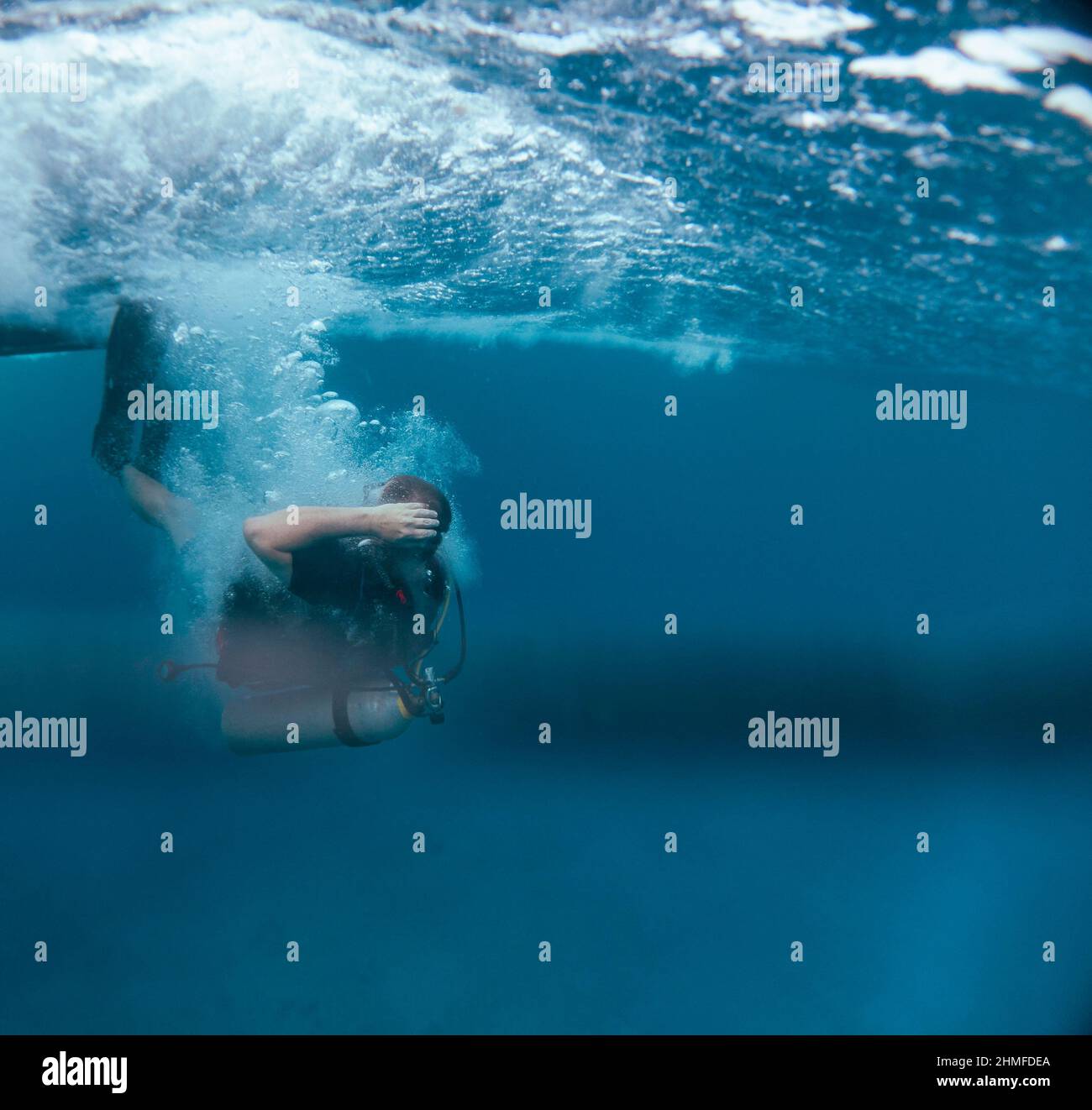 young scuba diver jumping into the water Stock Photo - Alamy