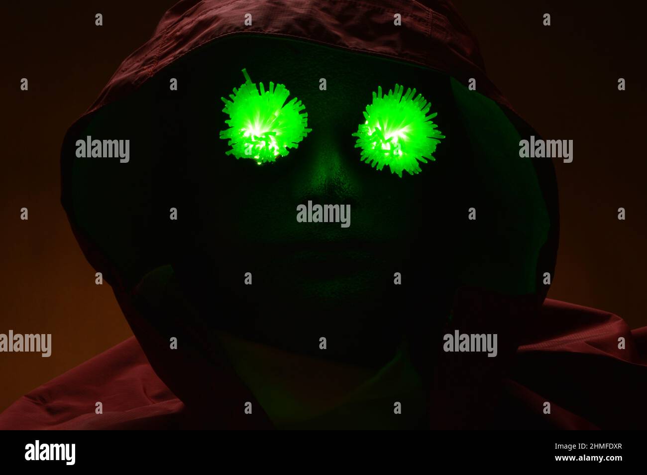Unusual green eyed stranger underneath hood Stock Photo - Alamy