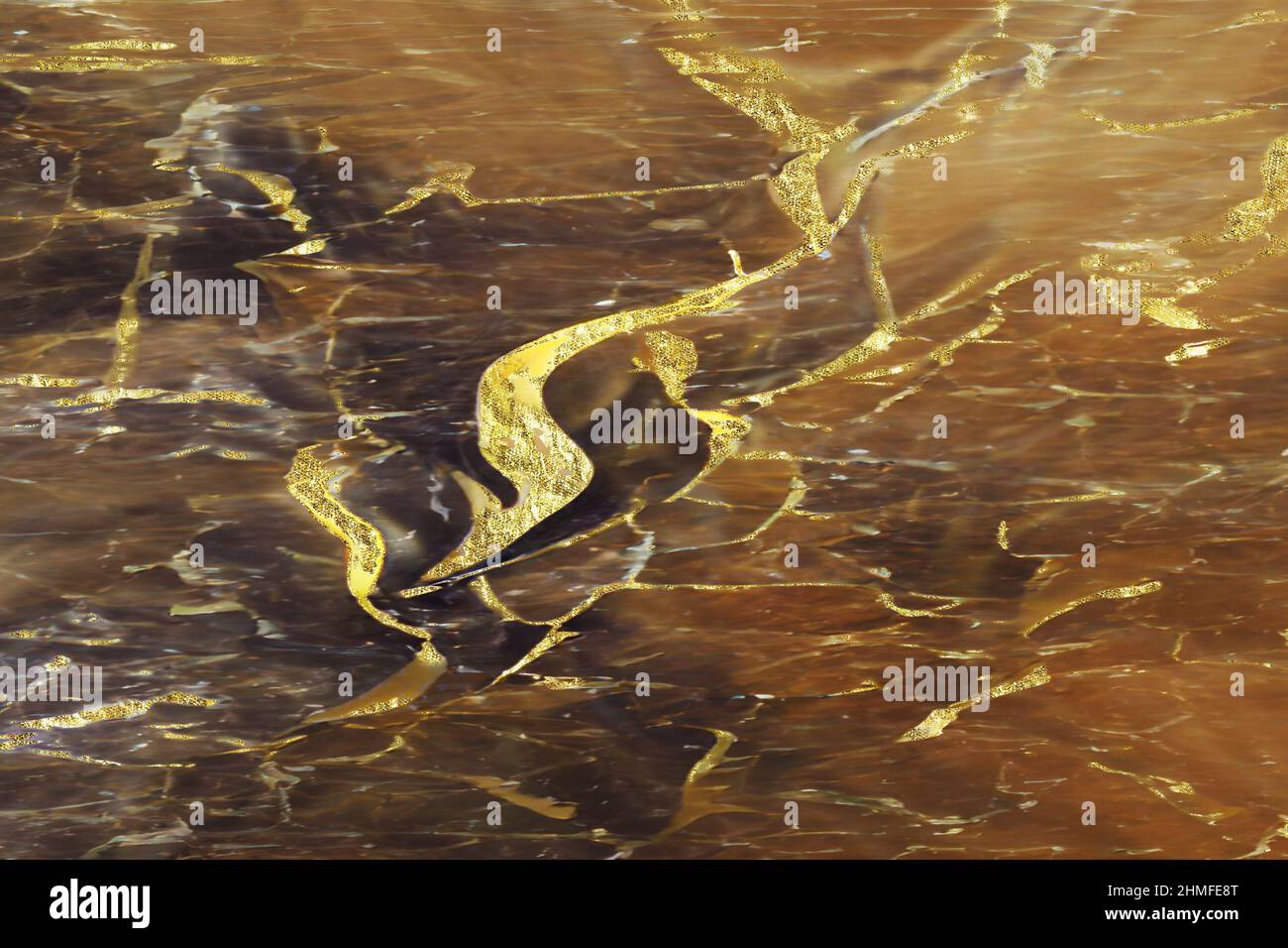 Gold metallic flowing through marbled stone backdrop in shades of brown ...
