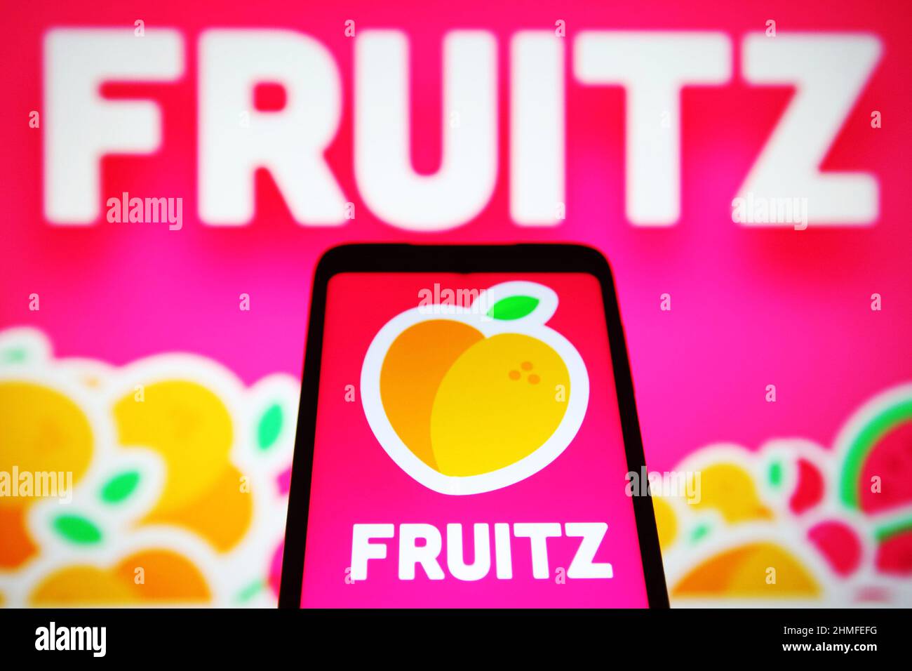 In this photo illustration, Fruitz logo is seen on a smartphone and a ...