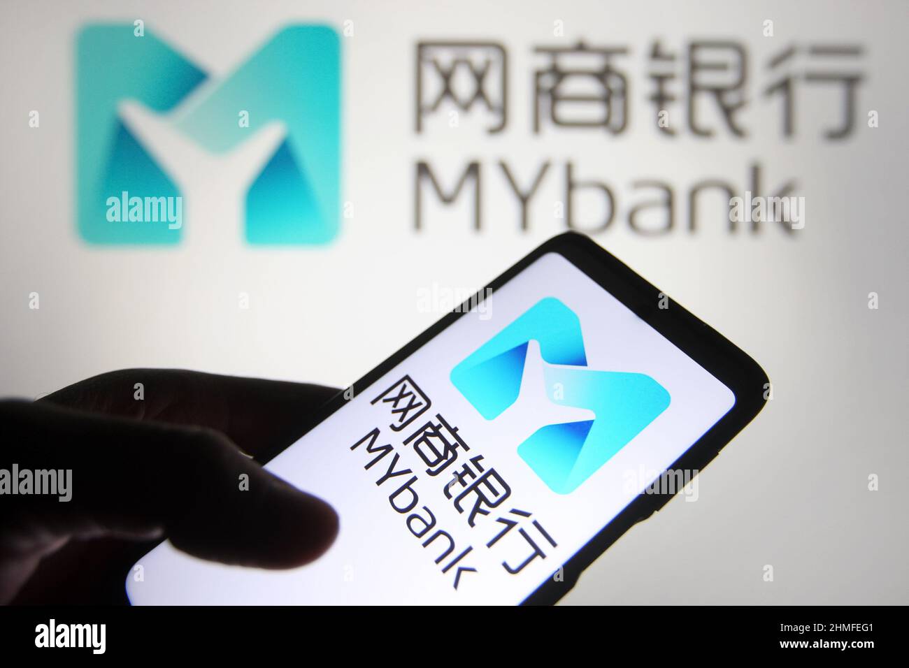 In this photo illustration, MYBank logo is seen on a smartphone and a ...