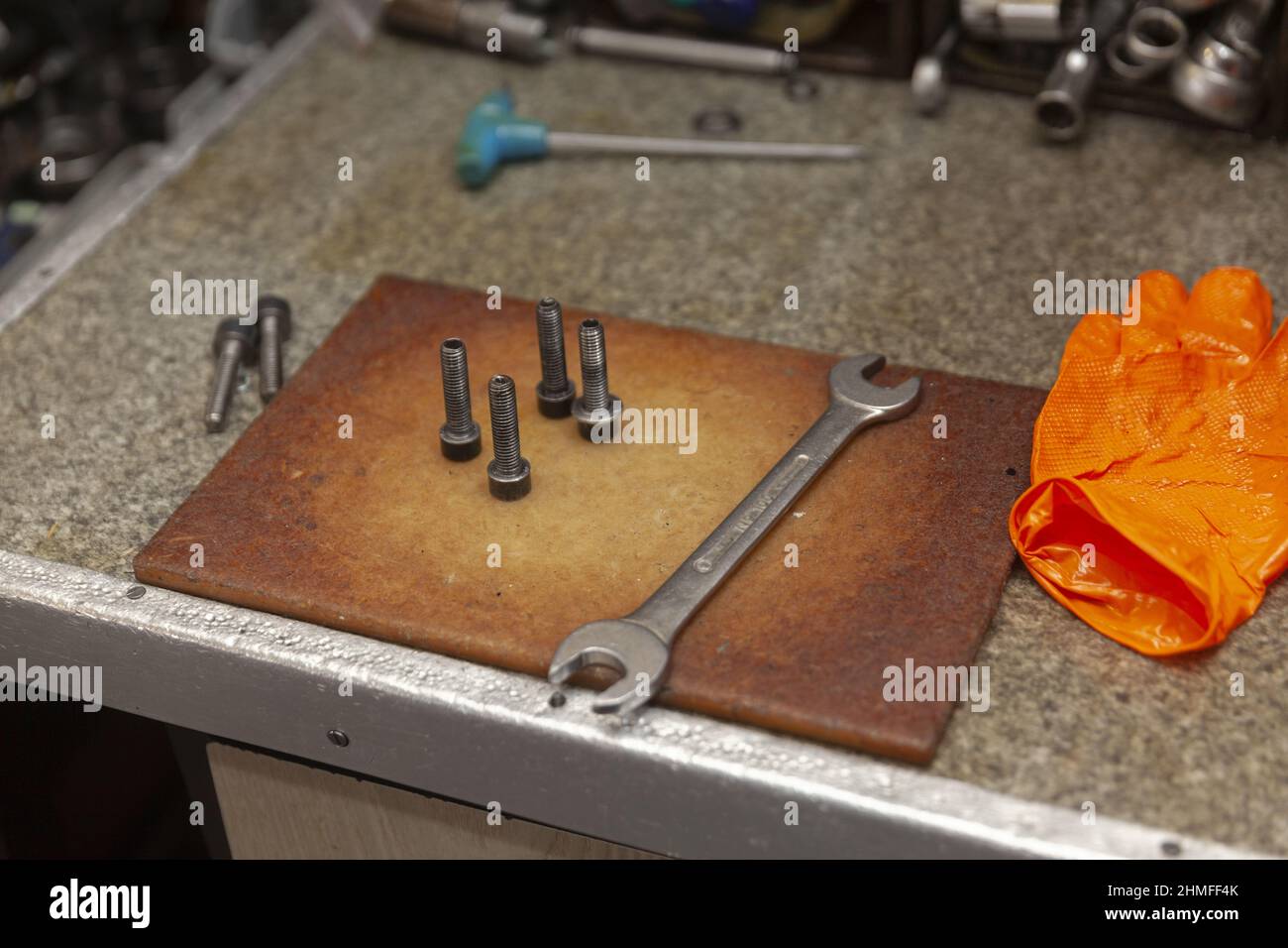 metal works table with wrench and bolts Stock Photo - Alamy