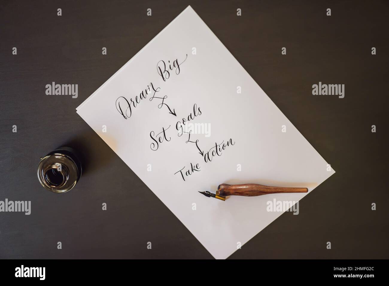 dream big set goals take action. Calligrapher Young Woman writes phrase ...