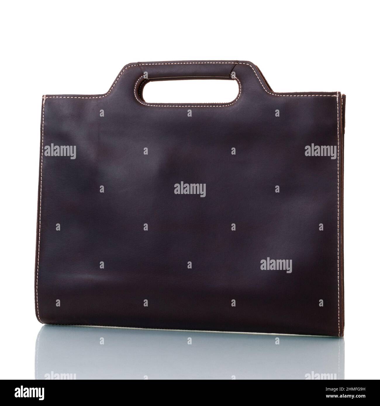 Brown leather bag of rectangular shape with cut-through handles. On a ...