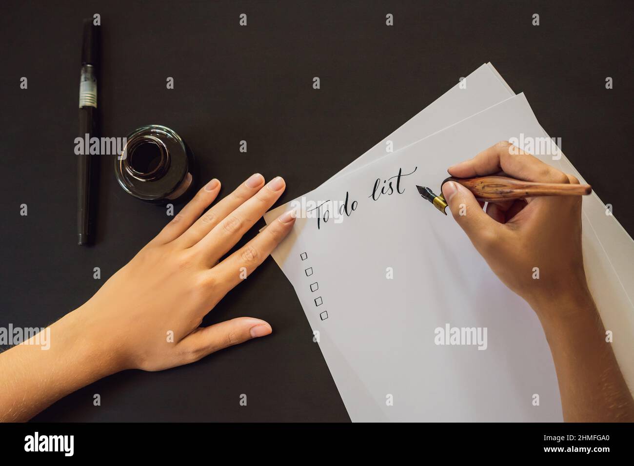To do list. Calligrapher Young Woman writes phrase on white paper ...