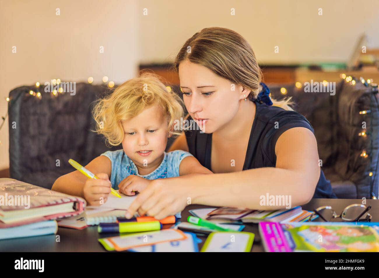 A teacher, a tutor for home schooling and a teacher at the table. Or mom and daughter ...