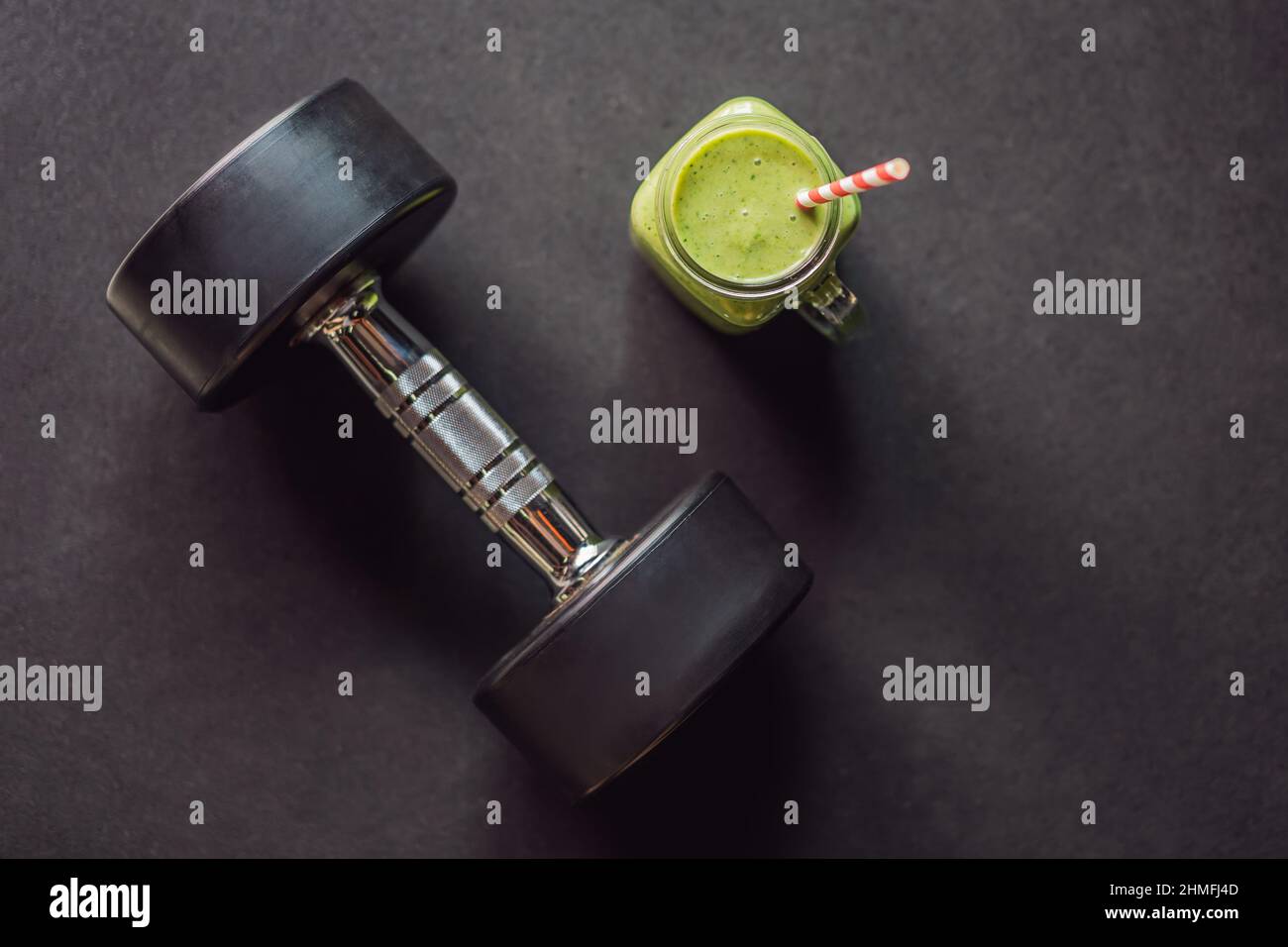Green smoothies and dumbbells in the gym Stock Photo - Alamy