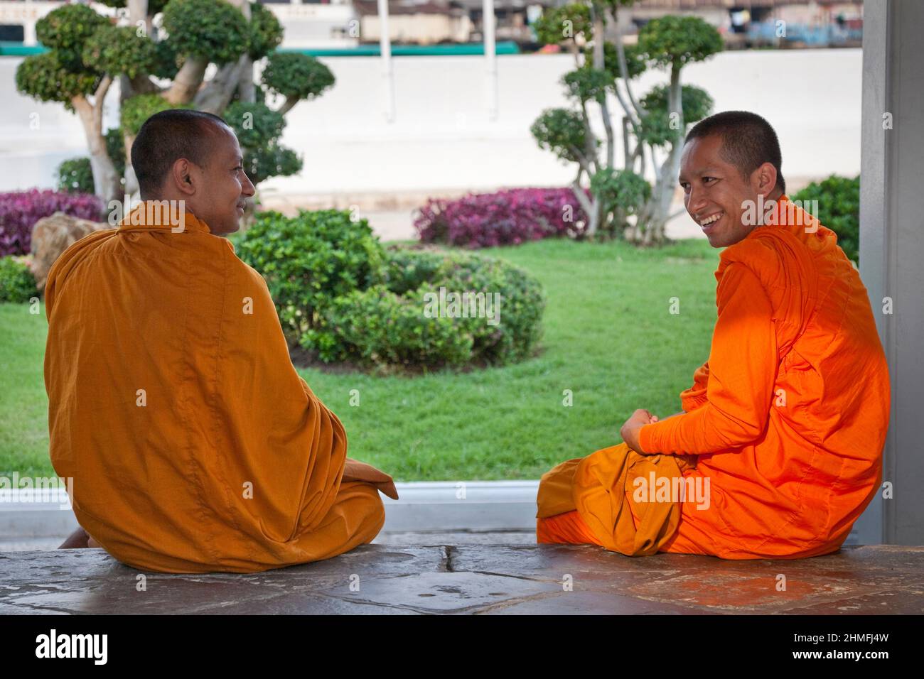 Two monks talking to each other in Thailand Stock Photo - Alamy