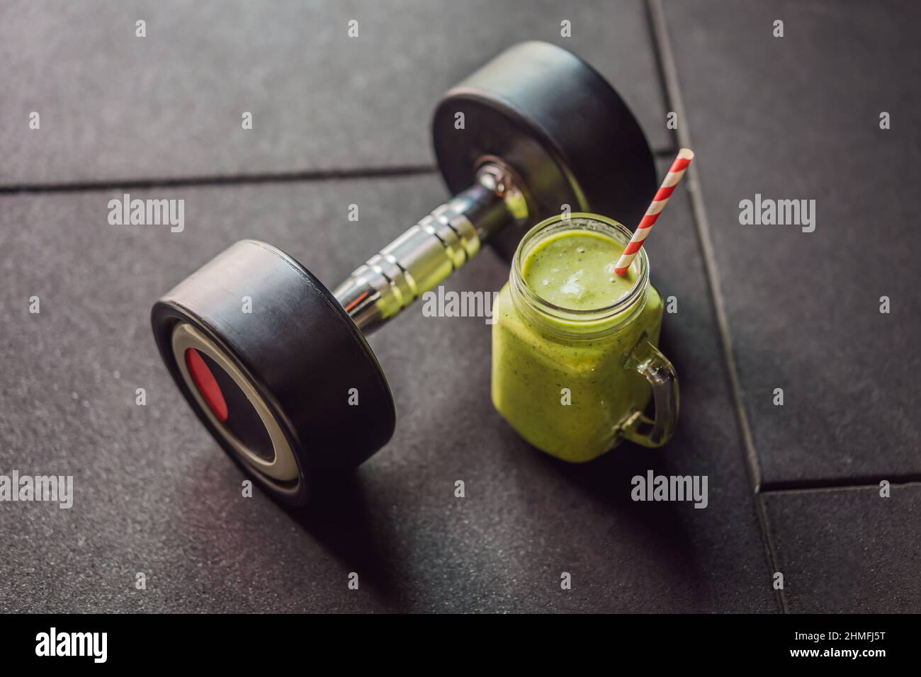 Green smoothies and dumbbells in the gym Stock Photo - Alamy