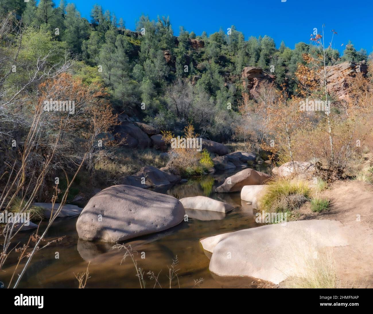 The Verde River winding through large boulders and fall cottonwood ...
