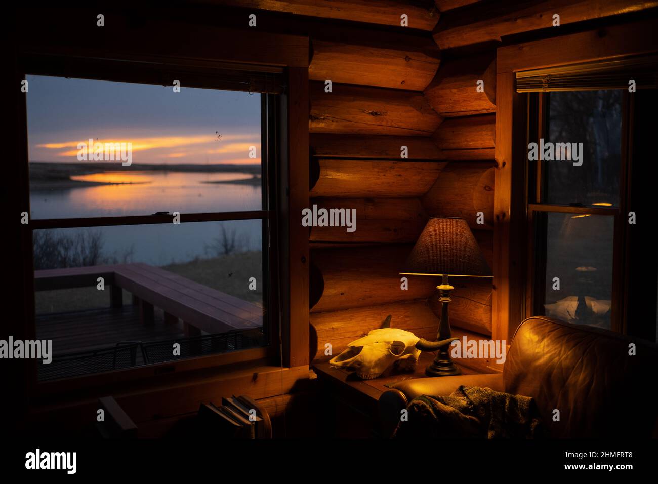 View from inside a cabin looking towards a lake during sunrise Stock ...