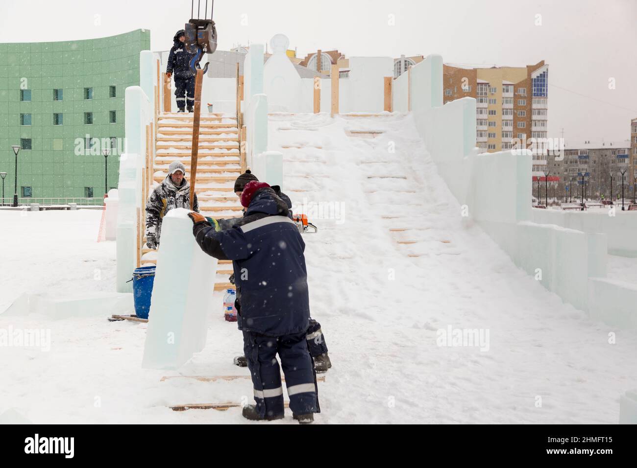 Installers at the installation of an ice slab for an ice town Stock ...