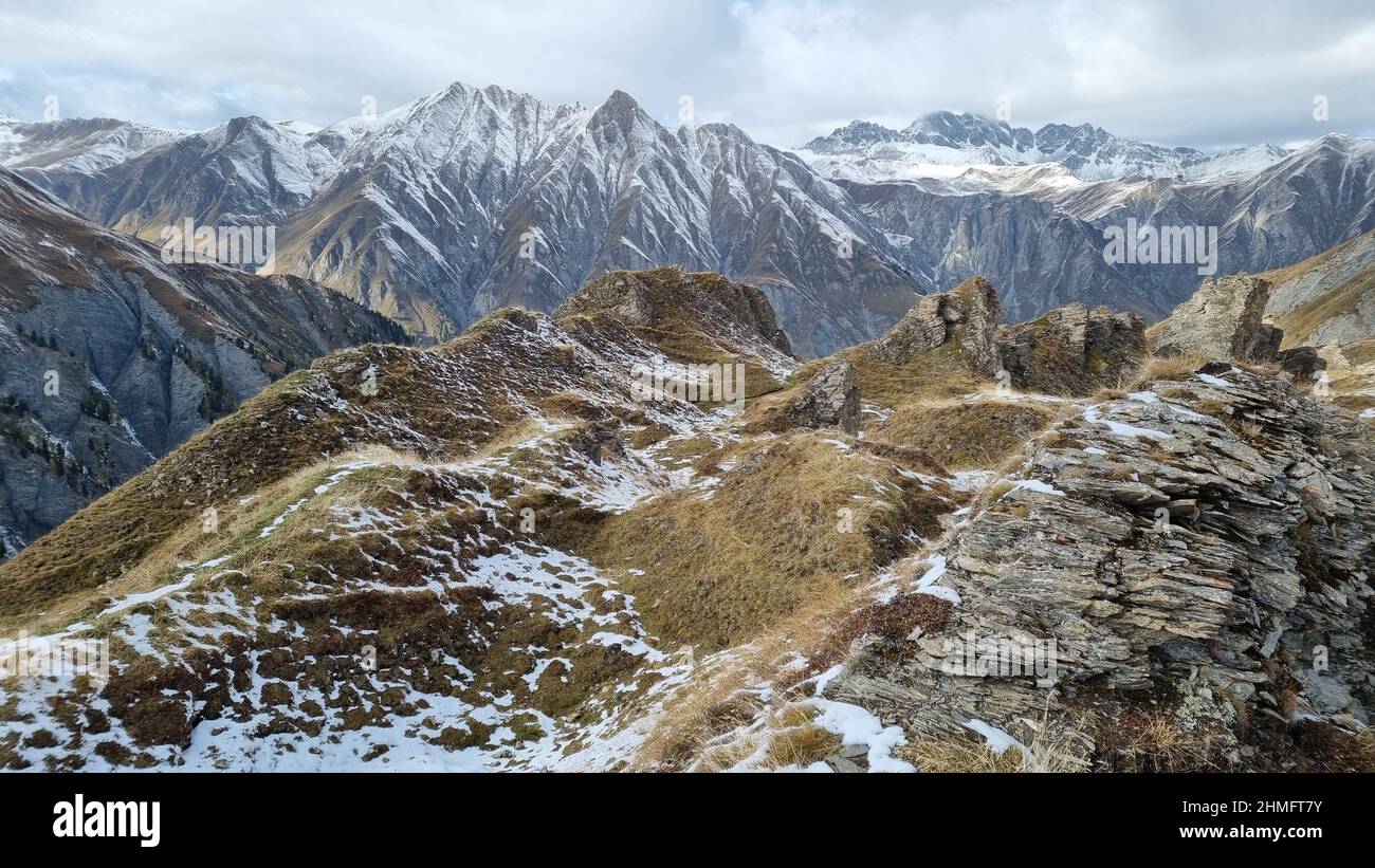 Beautiful shot of some mountains partly covered in snow in the daytime ...