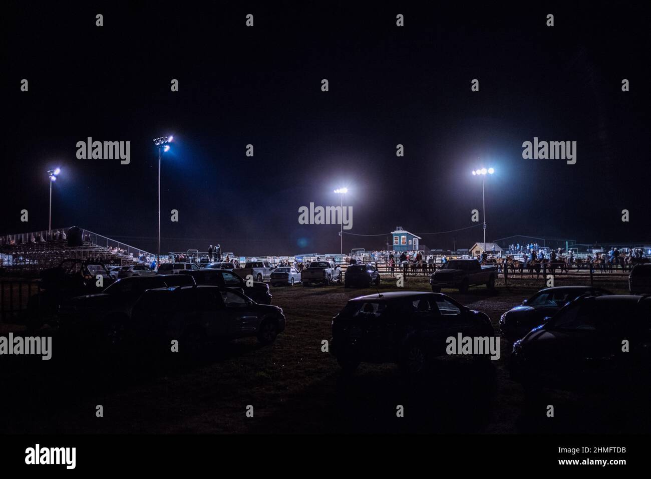 Rodeo Arena with lights on at night during summer from parking lot ...
