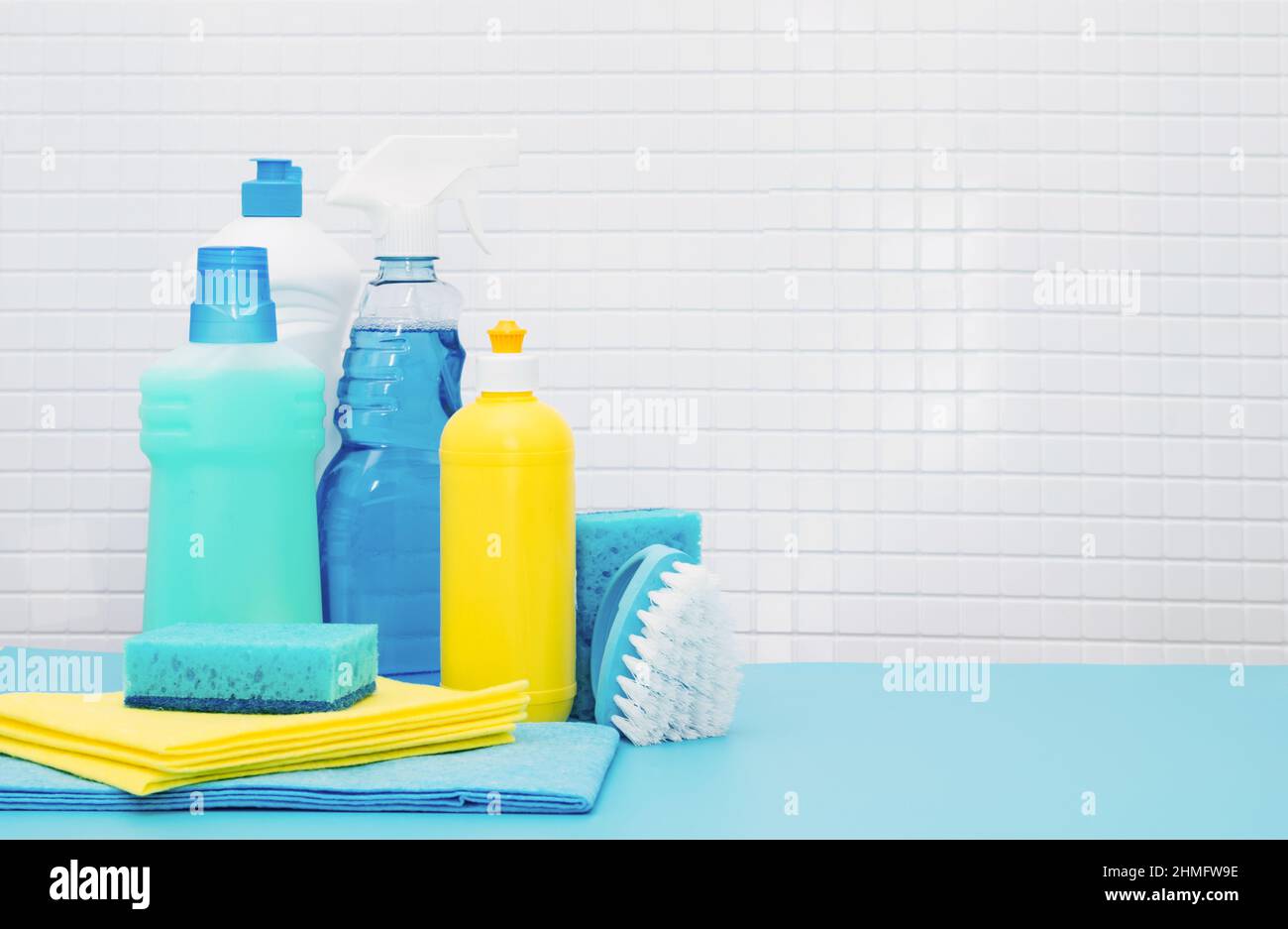 Set of cleaners and detergents, cleaning accessories, blue background ...