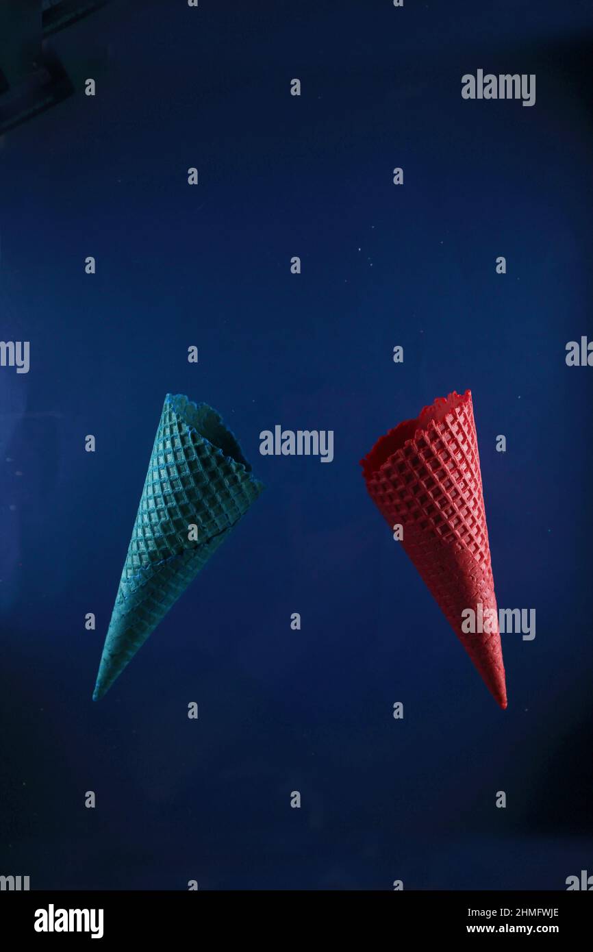 red and blue waffle cone isolated on blue background. Image contains ...