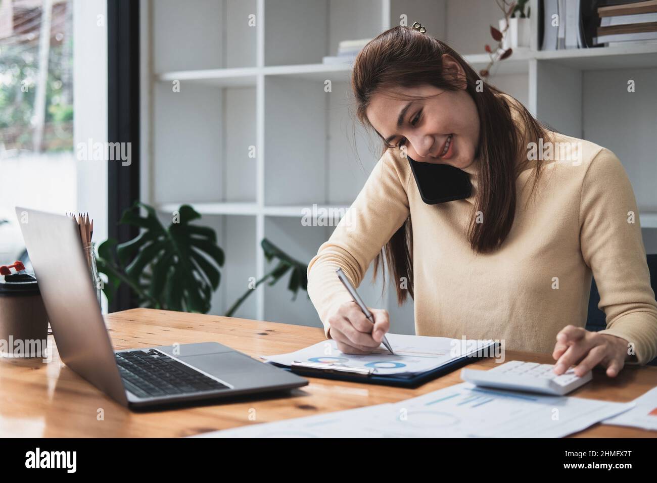 Asian business woman making a phone call, Accountant working Financial ...