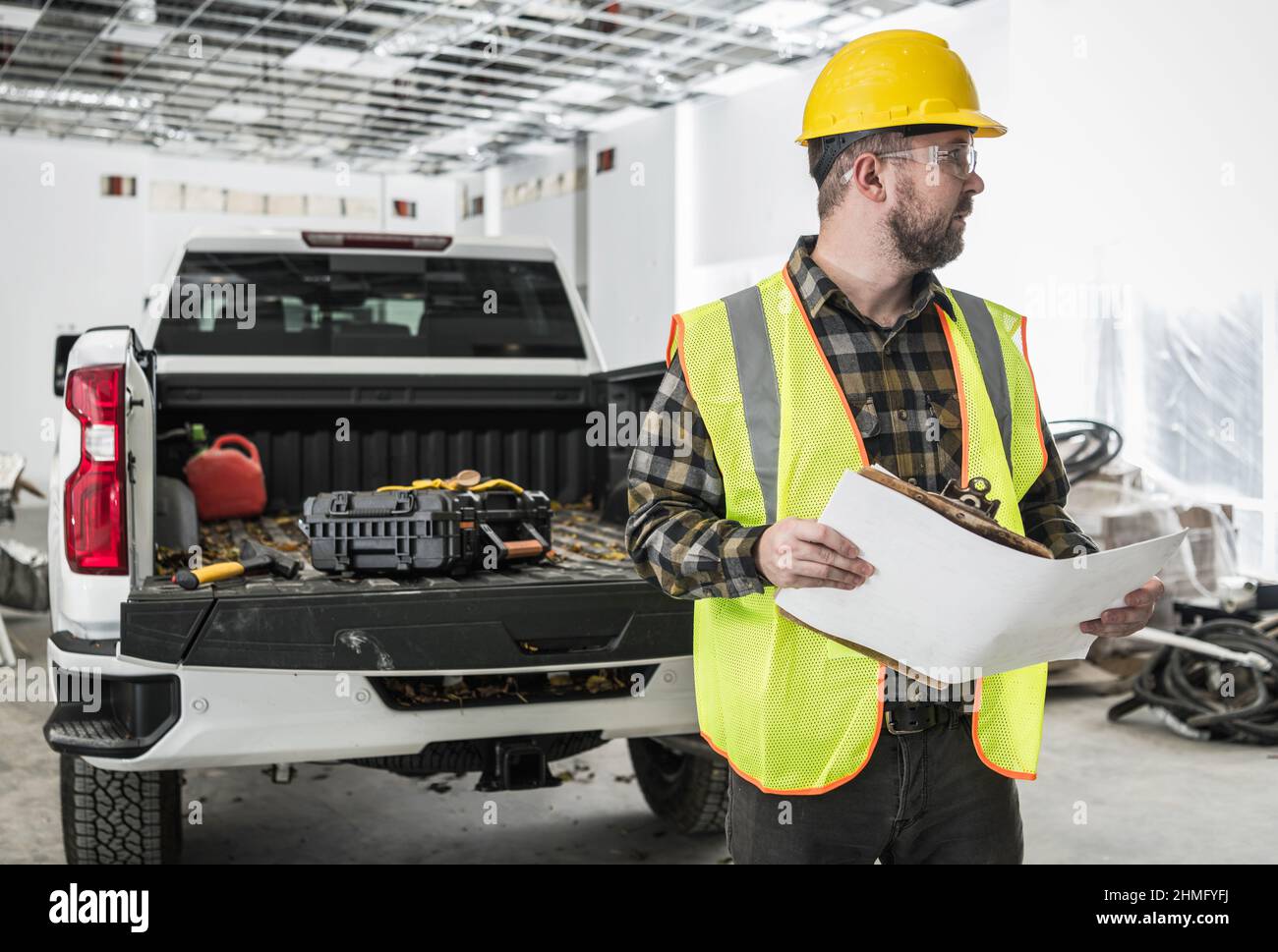 Construction Supervisor with Blueprints and Other Documents in His Hand ...
