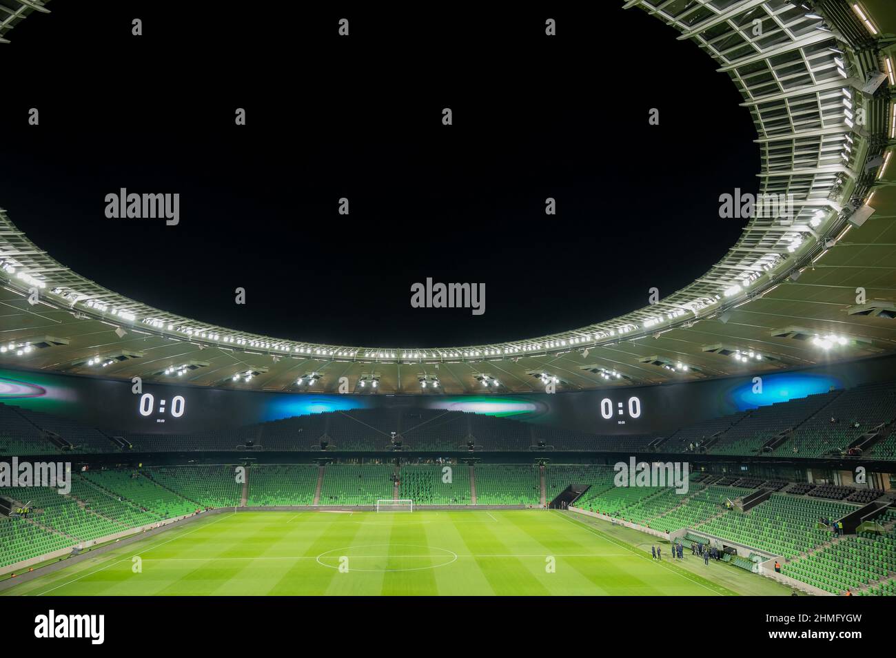 An open football stadium with empty stands with green seats Stock Photo ...