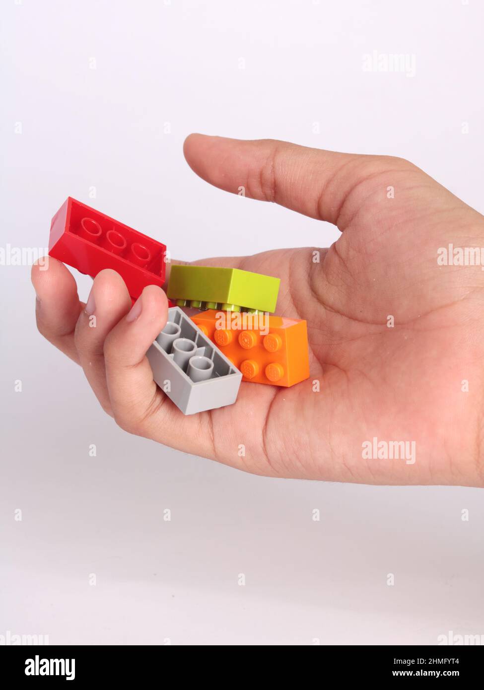 hand holding brick toys, isolated white background Stock Photo - Alamy