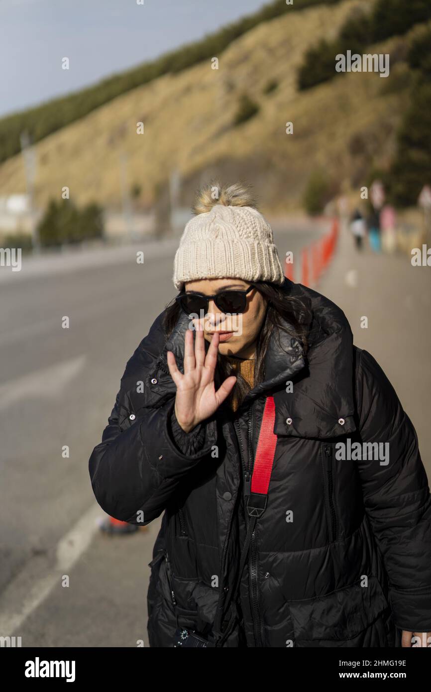 Vertical shot of a Caucasian woman walking on a roadside Stock Photo ...
