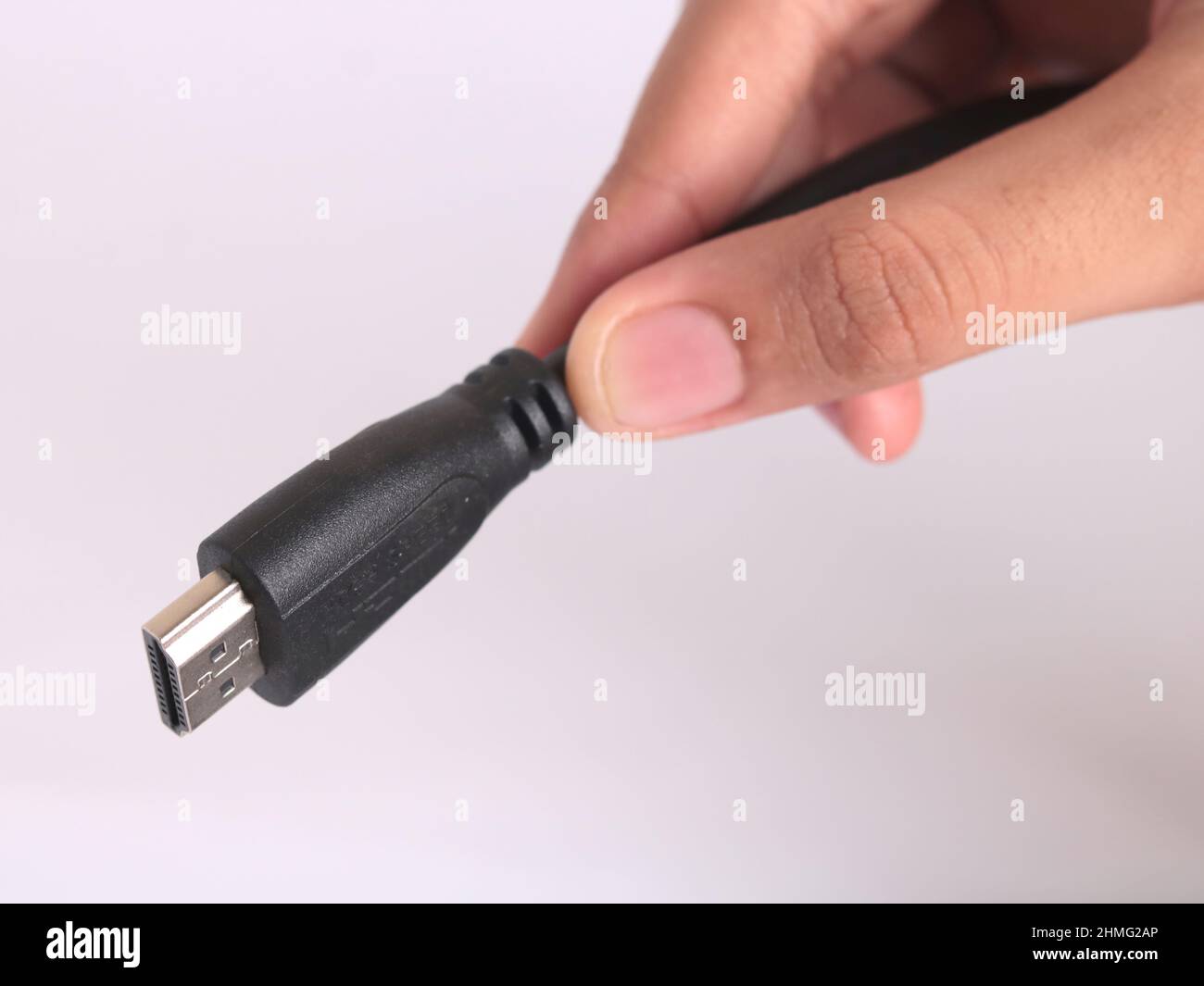 Hand holding HDMI cable Stock Photo - Alamy