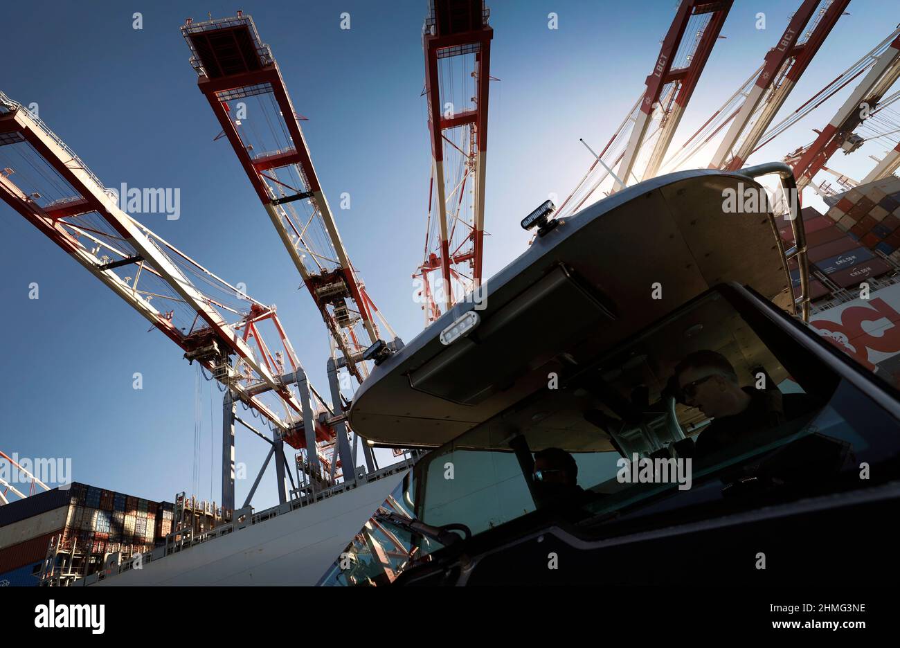 Cranes in the Port of Long Beach, Calif., tower over a U.S. Customs and ...