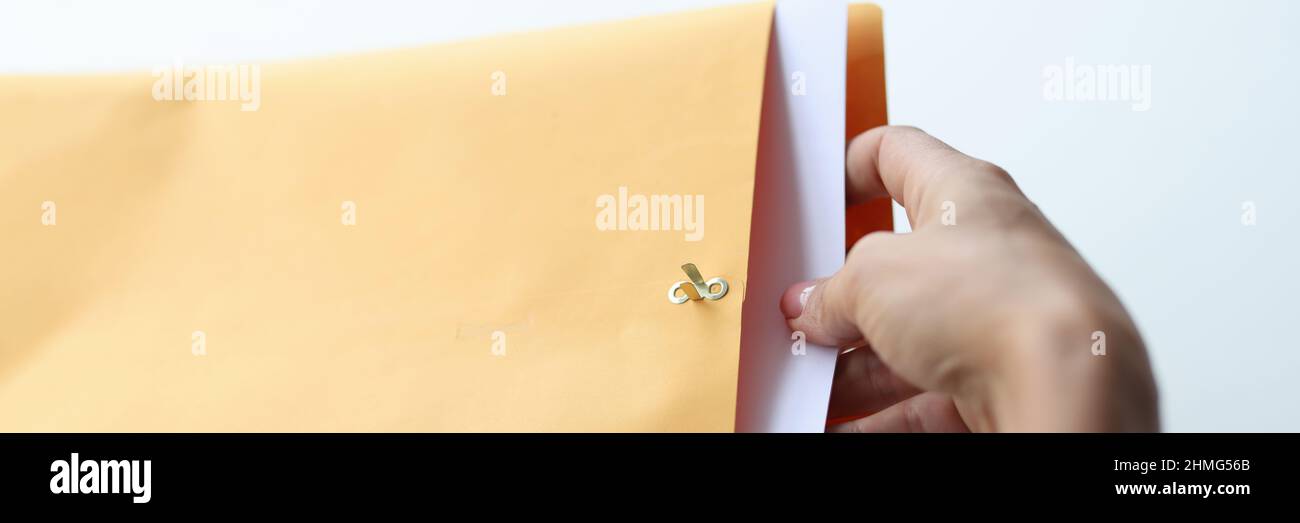 Woman hand takes out letter from envelope closeup Stock Photo - Alamy