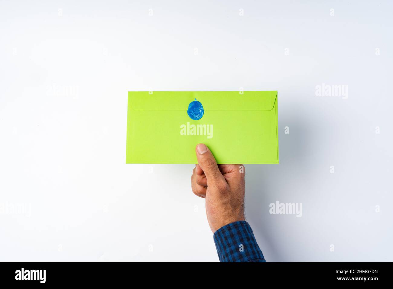 Male hand holding closed envelope above the white surface Stock Photo ...