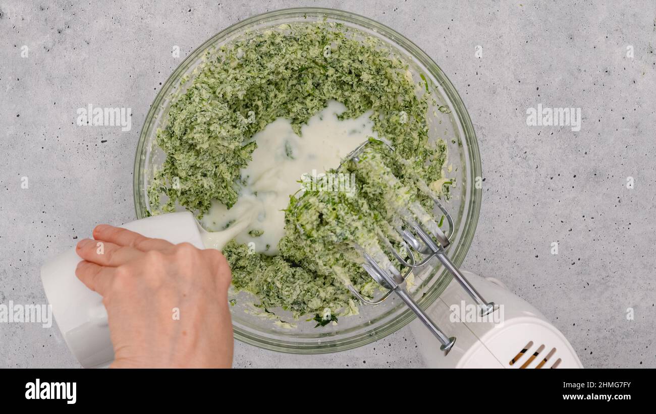Mascarpone and spinach mix close up in a glass bowl on light grey ...