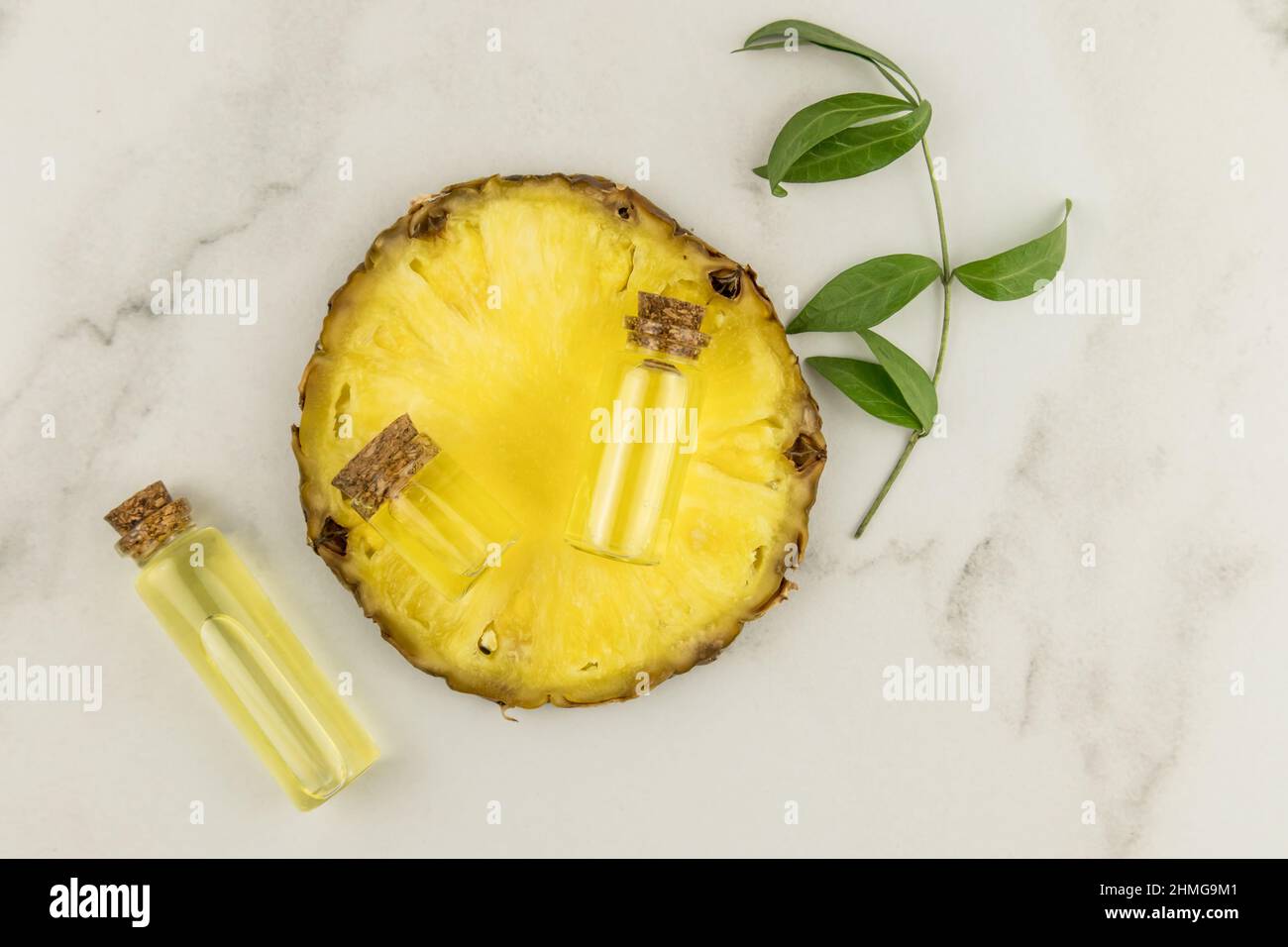 top view of a round juicy pineapple slice with glass bottles with a ...