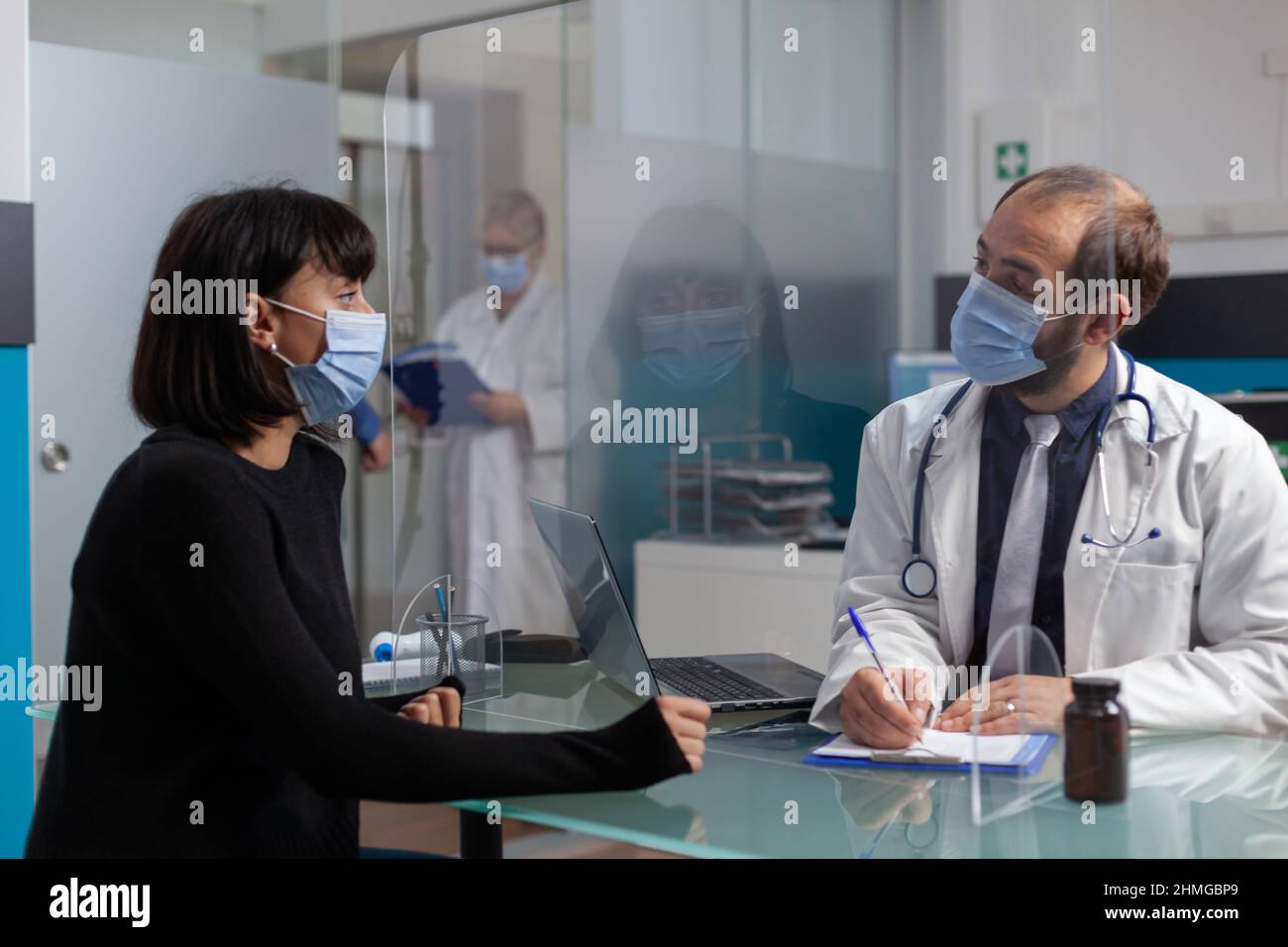 Health specialist taking notes at medical consultation in office, doing ...