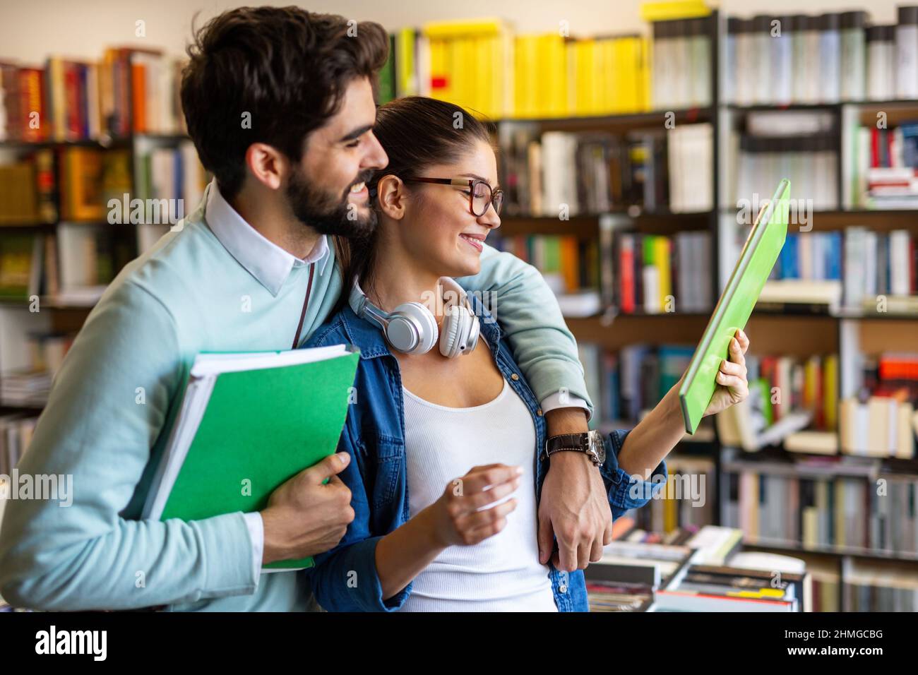 Group of happy college students studying in the school library ...