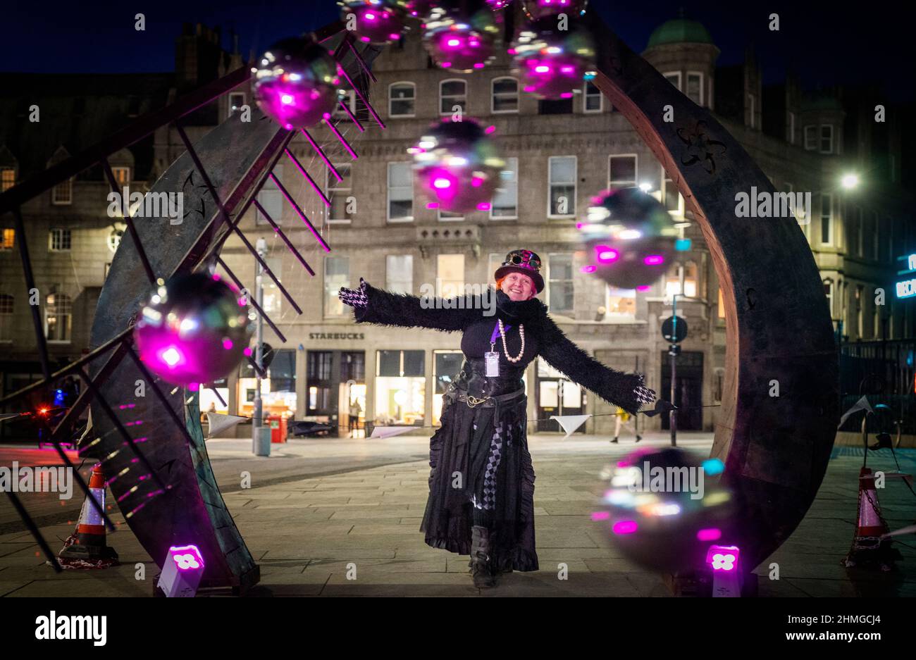 Julie Brown, from Travelling Light Circus looks through the Pendulum Wave Machine in Broad ...