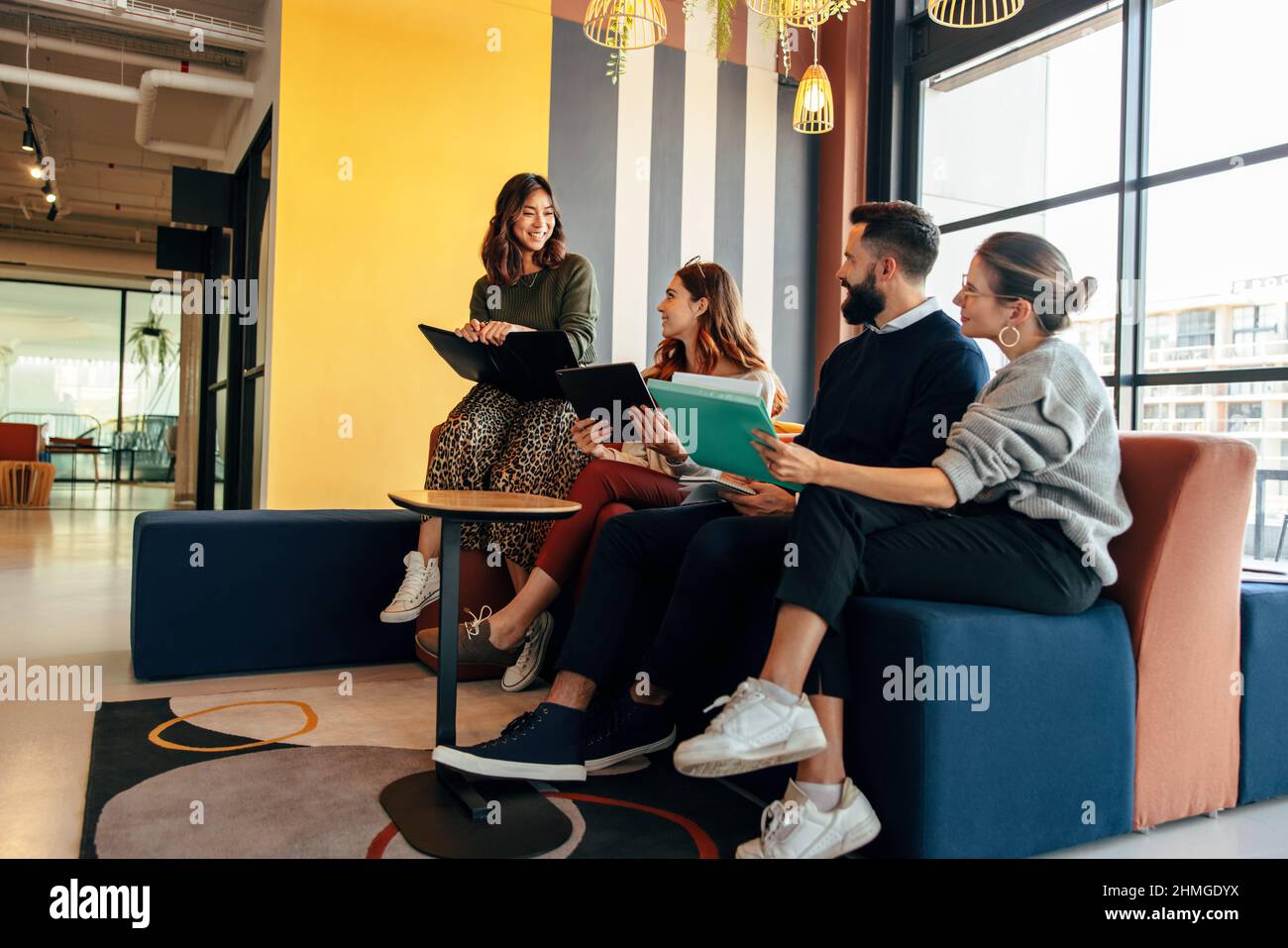 Group of multicultural businesspeople working in an office lobby. Team ... Group of multicultural businesspeople working in an office lobby. Team ...