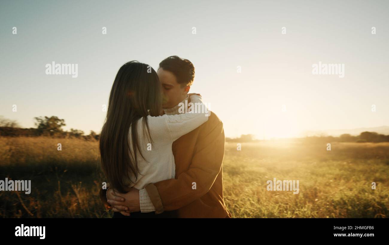 Romantic Couple Hugging outdoor at sunset light Stock Photo - Alamy