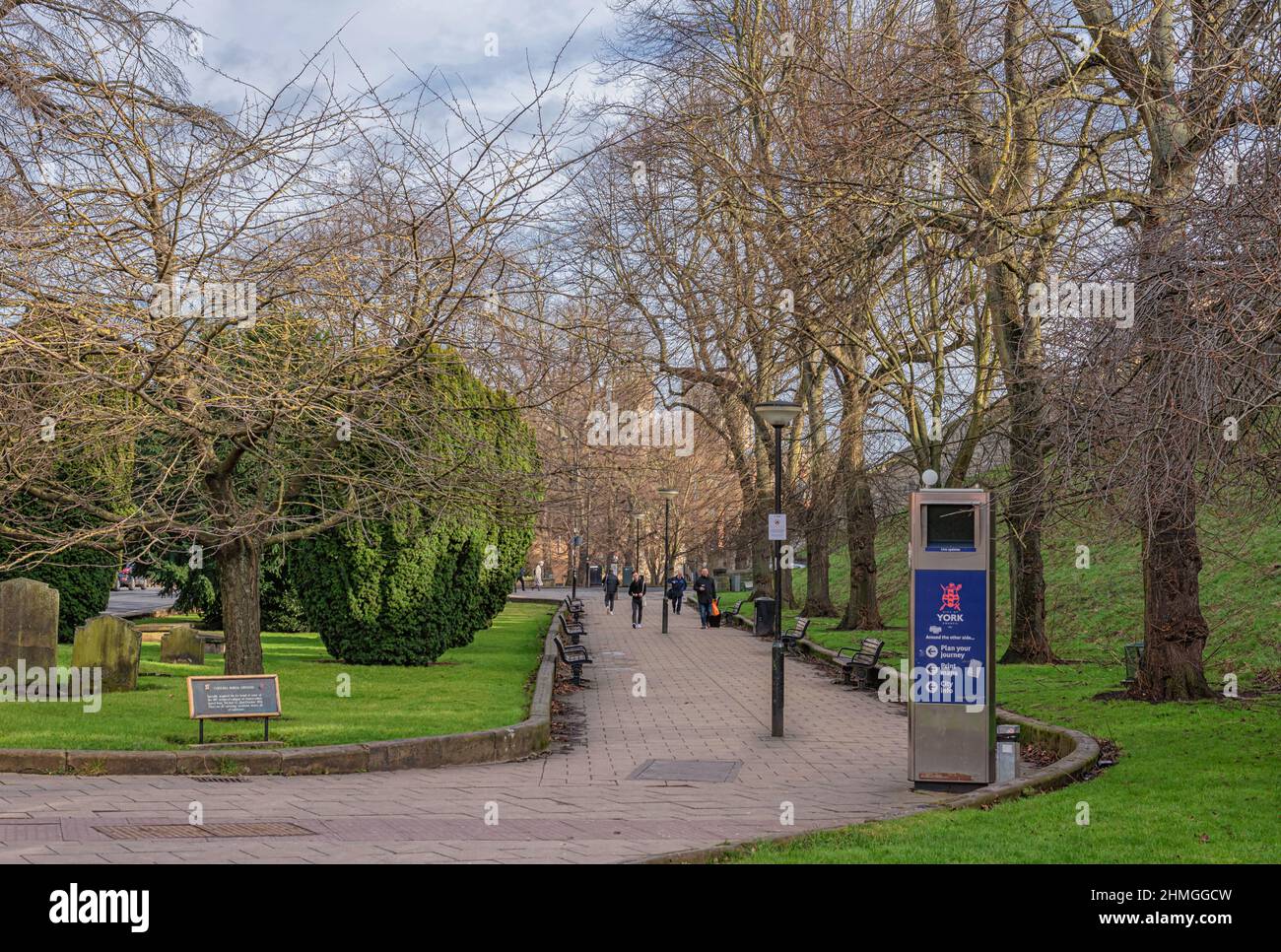 A path running between trees and alongside a Victorian cholera burial ...