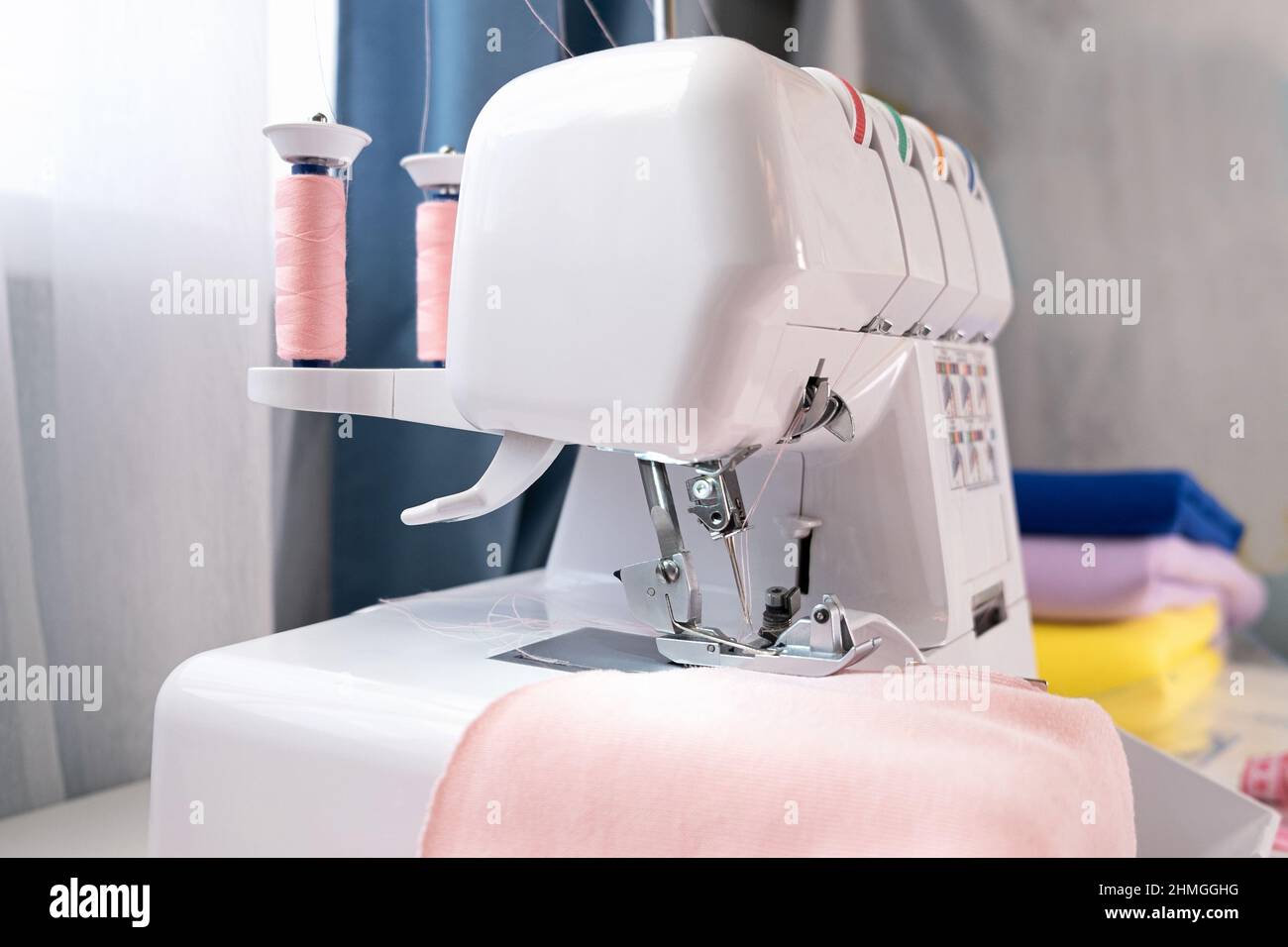 overlock. sewing clothes using a sewing machine at home. Seamstress ...