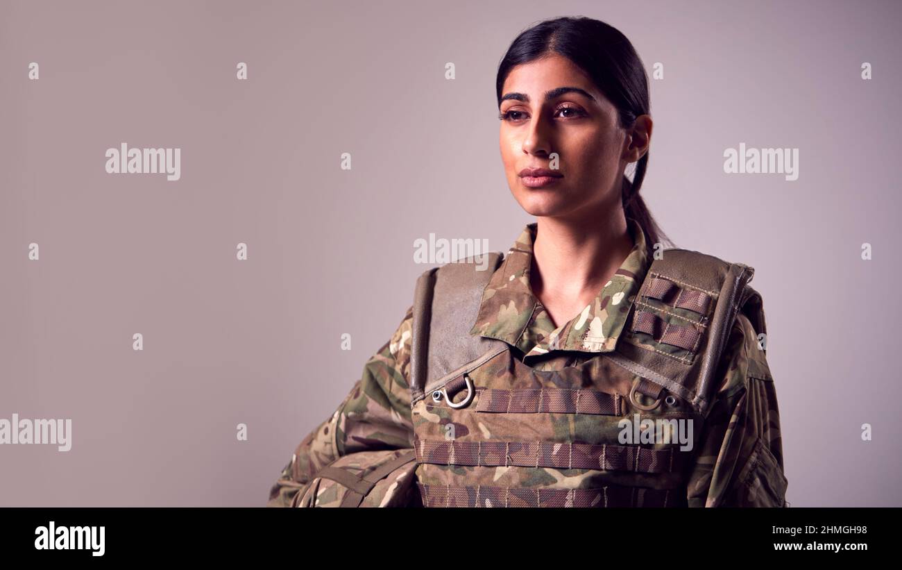 Studio Portrait Of Serious Young Female Soldier In Military Uniform ...