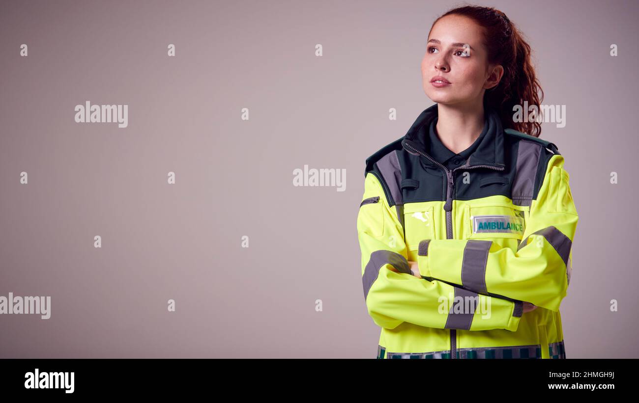 Studio Portrait Of Serious Young Female Paramedic Against Plain ...