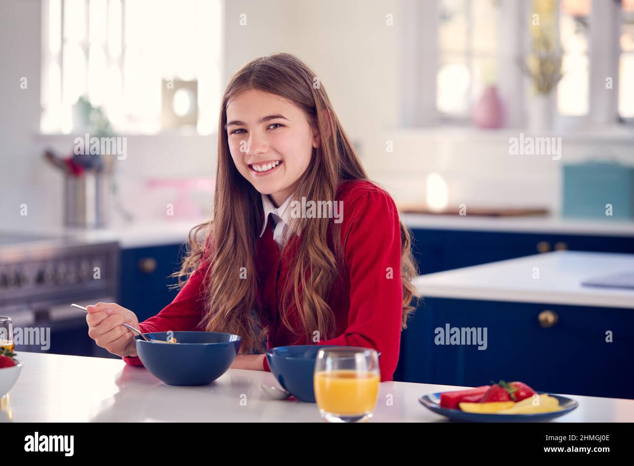 Portrait Of Smiling Teenage Girl Wearing School Uniform In Kitchen ...