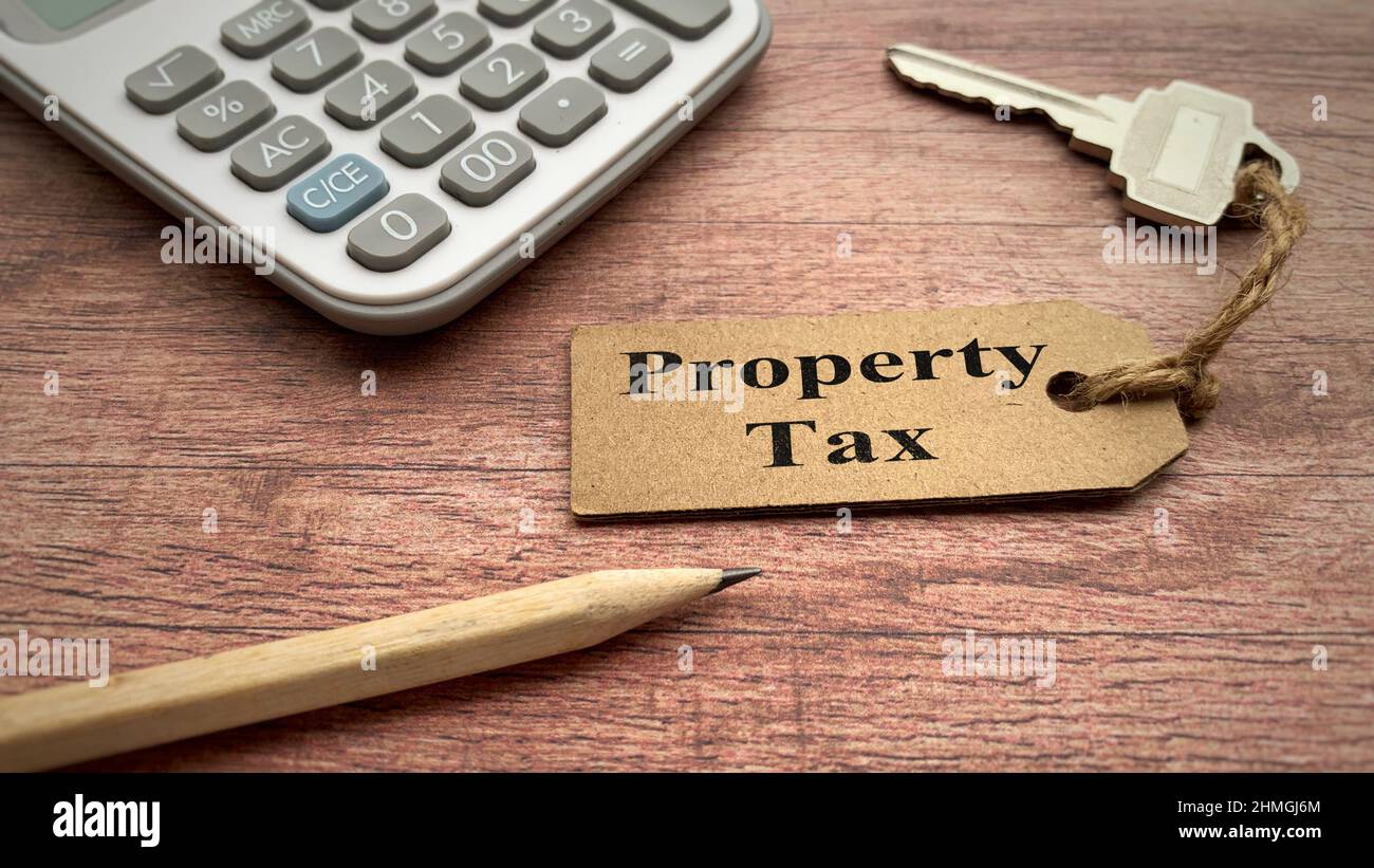 Property Tax text on keychain with calculator, pencil and wooden desk ...