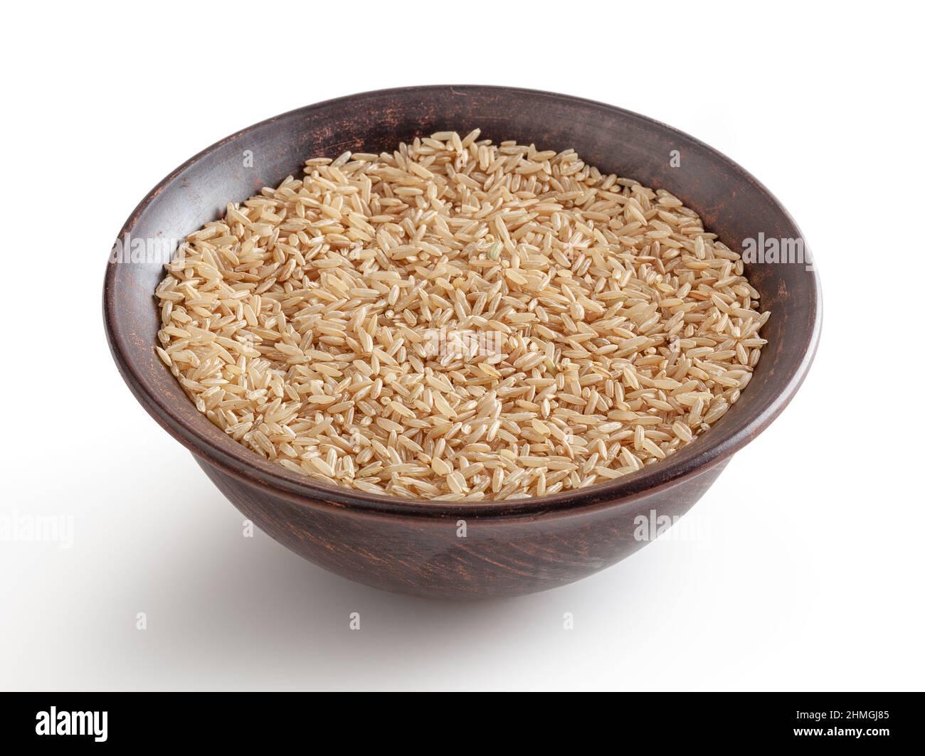 Brown rice in ceramic bowl isolated on white background with clipping ...